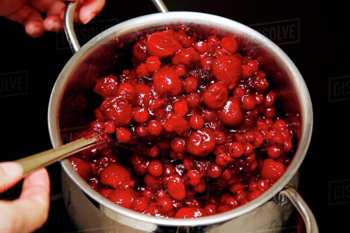 Red berry compote in a pan - Royalty-free Stock Photo | Dissolve