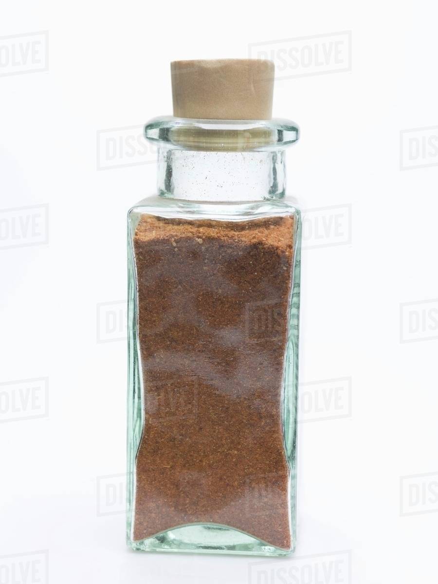 Grated nutmeg in small glass bottle - Royalty-free Stock Photo | Dissolve