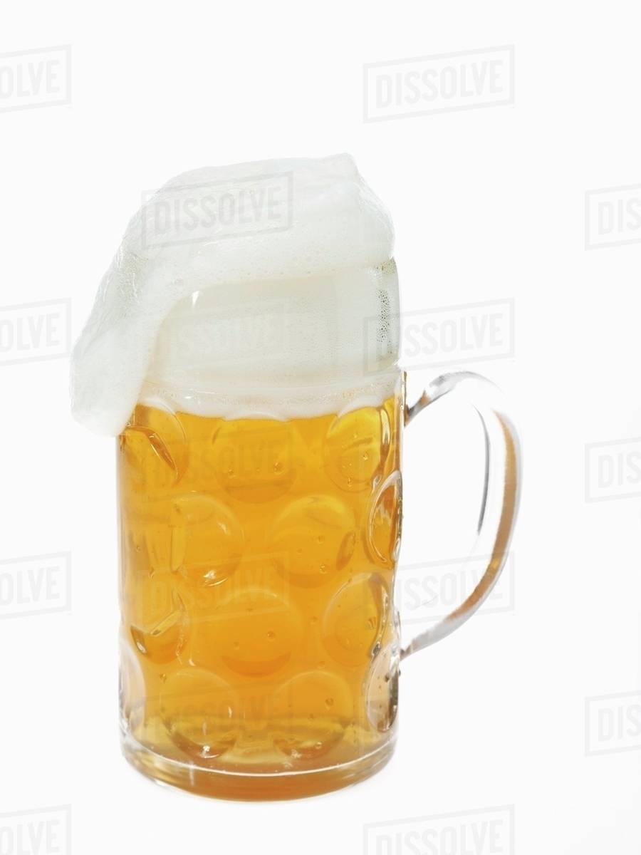 Beer in litre tankard with overflowing foam - Royalty-free Stock Photo ...