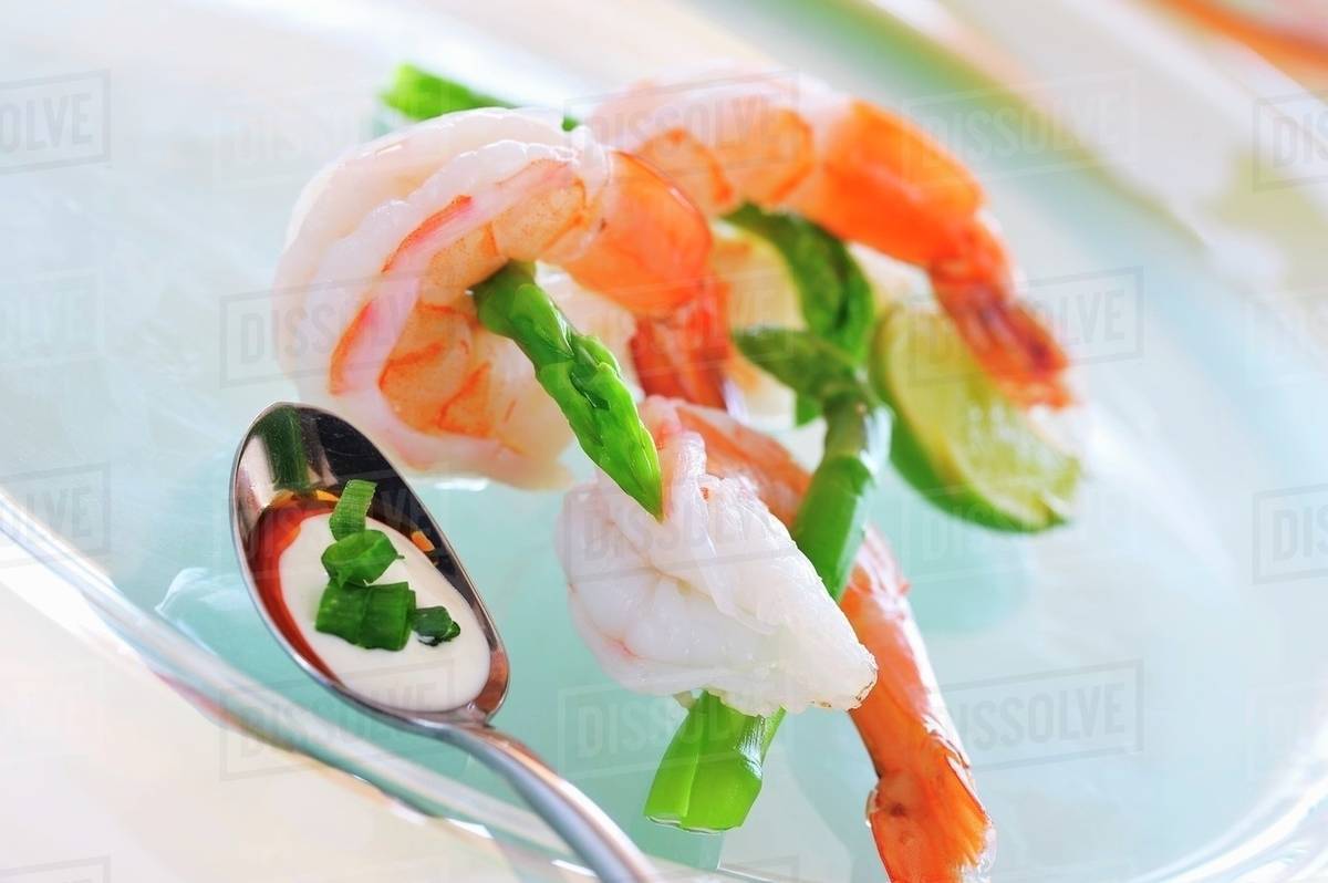 Two prawns with green asparagus - Stock Photo - Dissolve