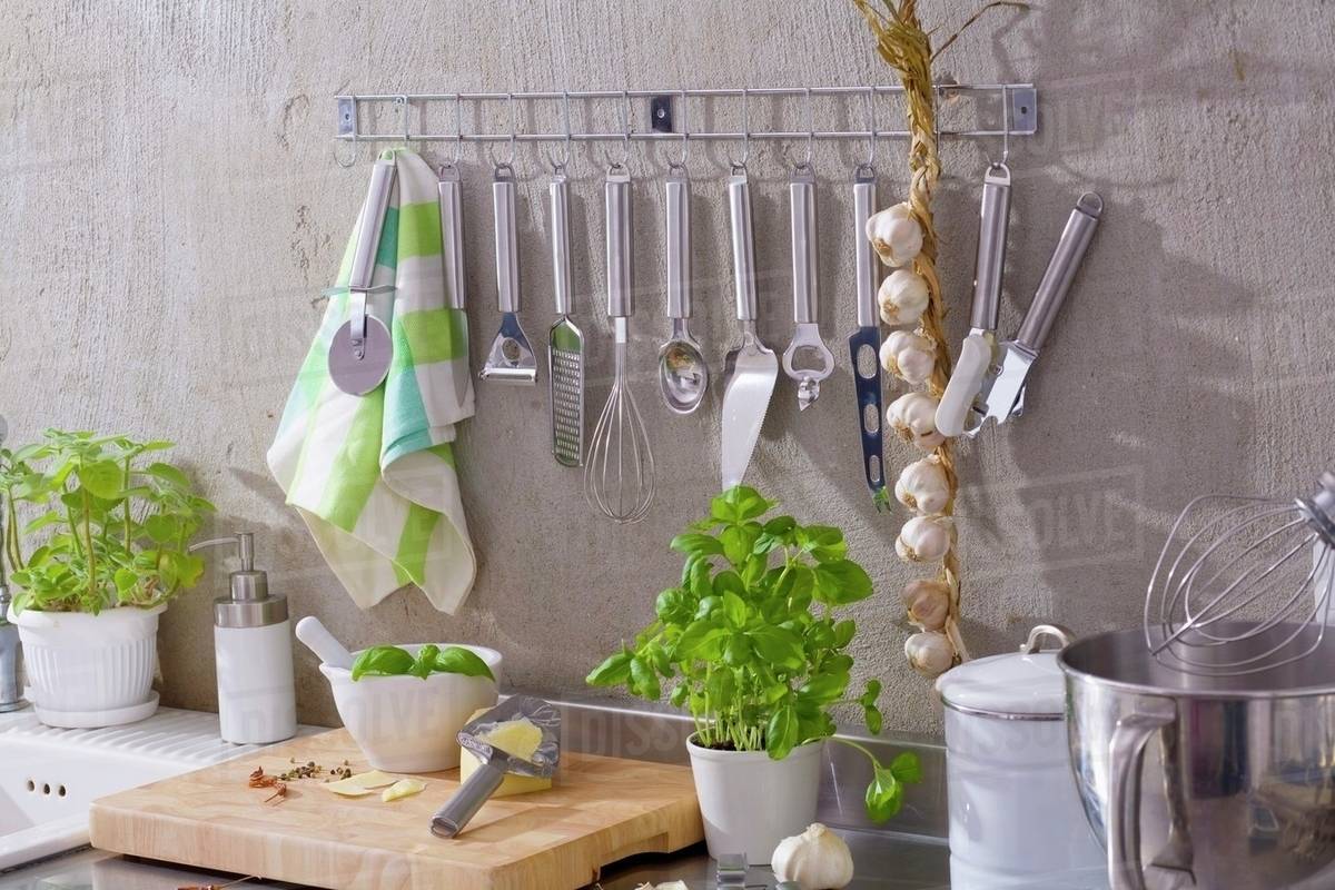 Kitchen utensils, string of garlic, basil, Parmesan etc. - Stock Photo ...