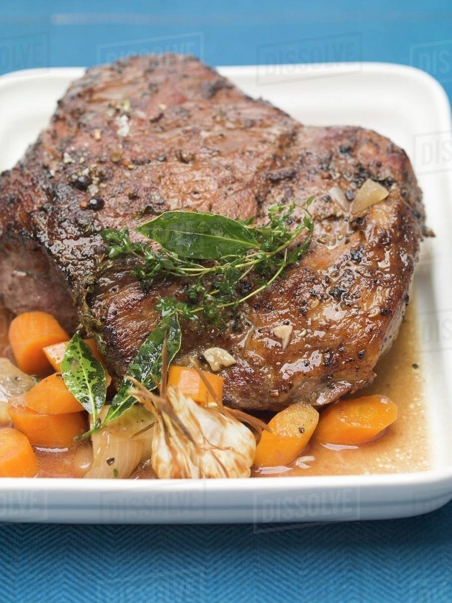 Boned leg of wild boar with carrots - Royalty-free Stock Photo | Dissolve