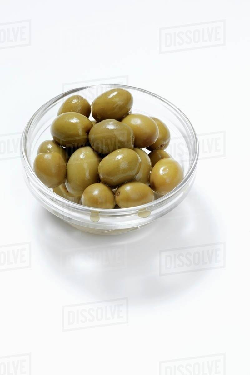 Green olives in small glass dish - Royalty-free Stock Photo | Dissolve