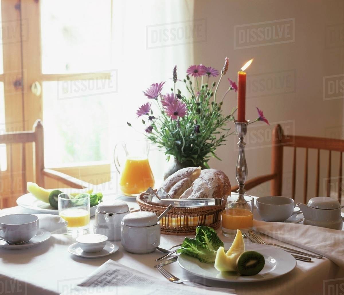 Laid breakfast table with baked goods, juice and fruit - Royalty-free ...