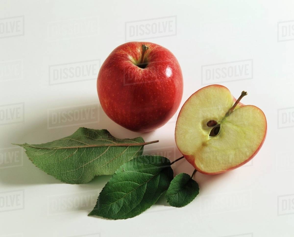 A whole red apple and half a red apple with leaves - Royalty-free Stock ...