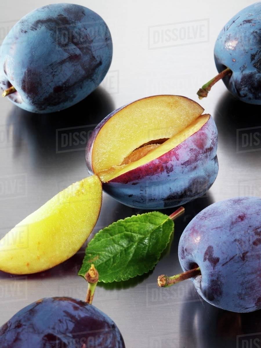 Fresh plums, whole and one with a section cut out - Royalty-free Stock ...