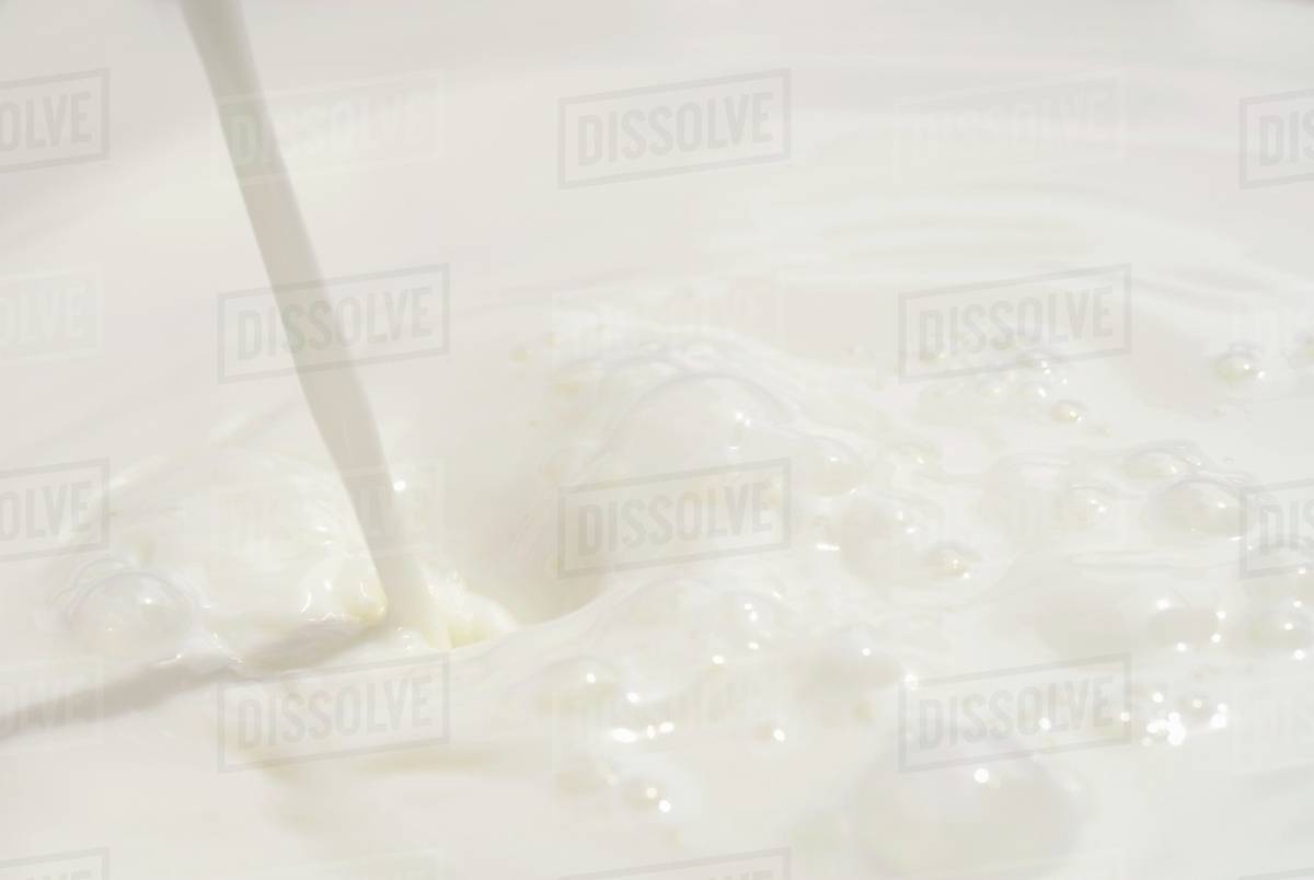 Pouring milk (full-frame) - Royalty-free Stock Photo | Dissolve