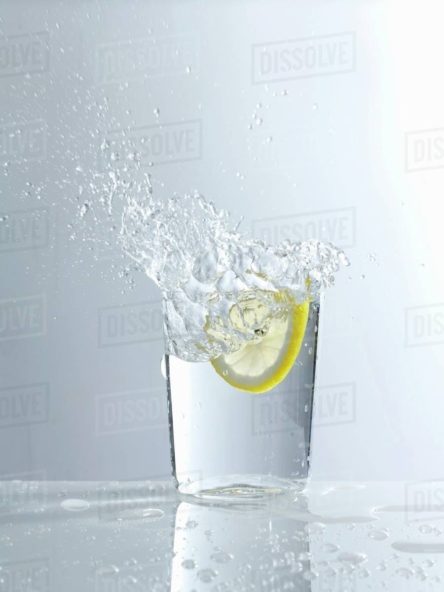 Water splashing out of a glass - Stock Photo - Dissolve