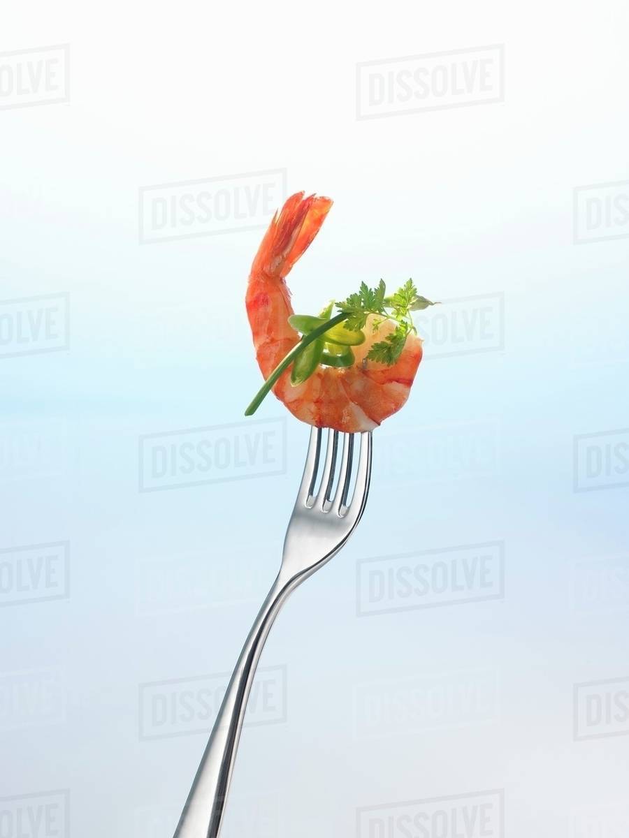 Prawn and herbs on a fork - Stock Photo - Dissolve