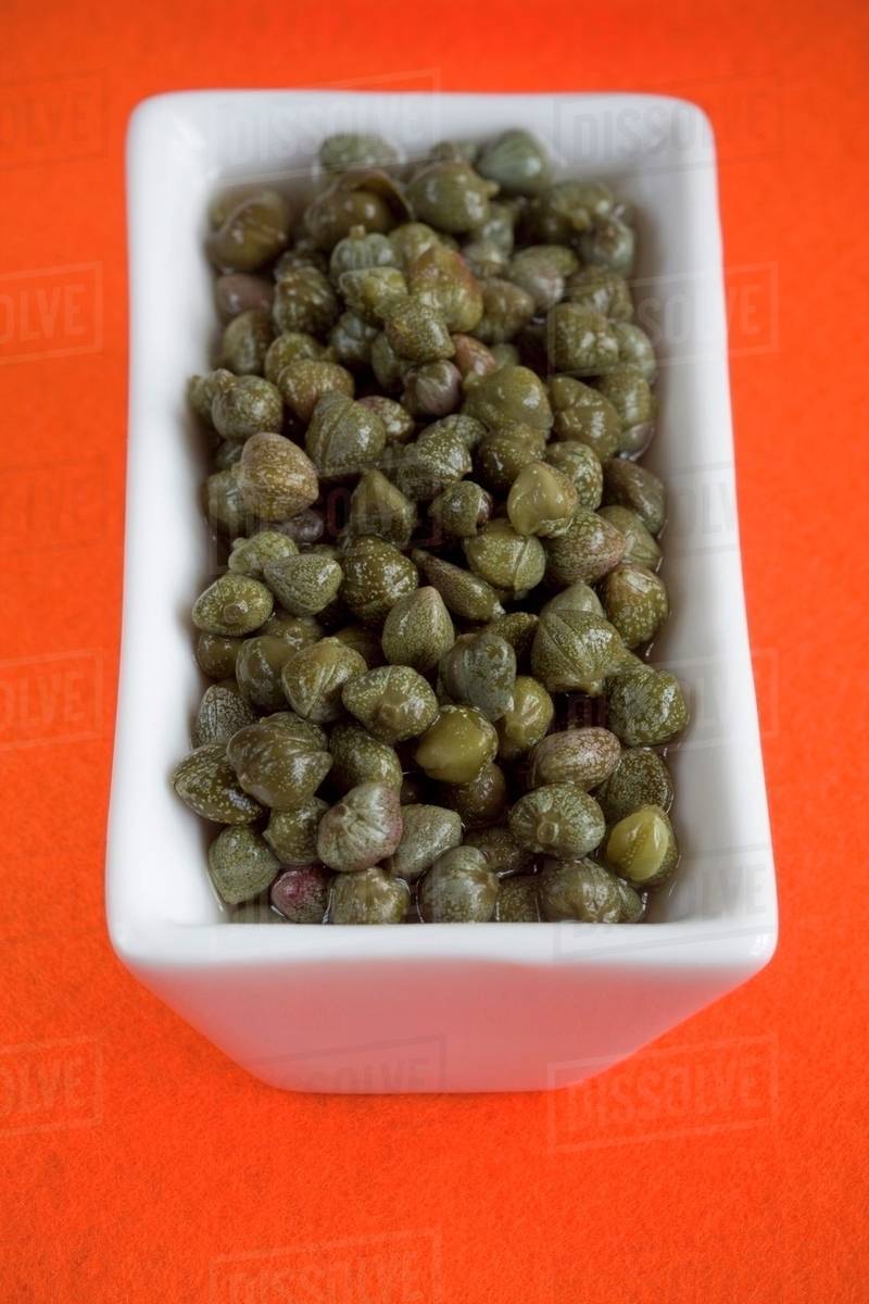 Pickled capers in a small dish - Royalty-free Stock Photo | Dissolve
