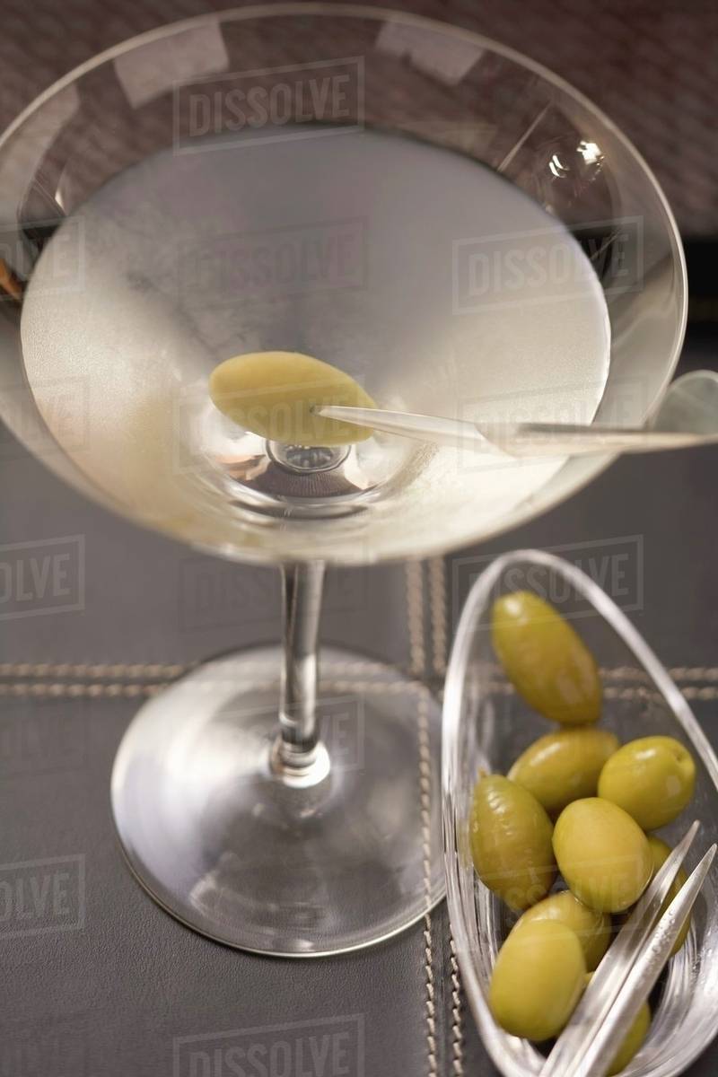 Martini with olives (overhead view) - Stock Photo - Dissolve