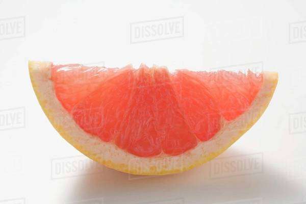 Wedge of pink grapefruit - Stock Photo - Dissolve