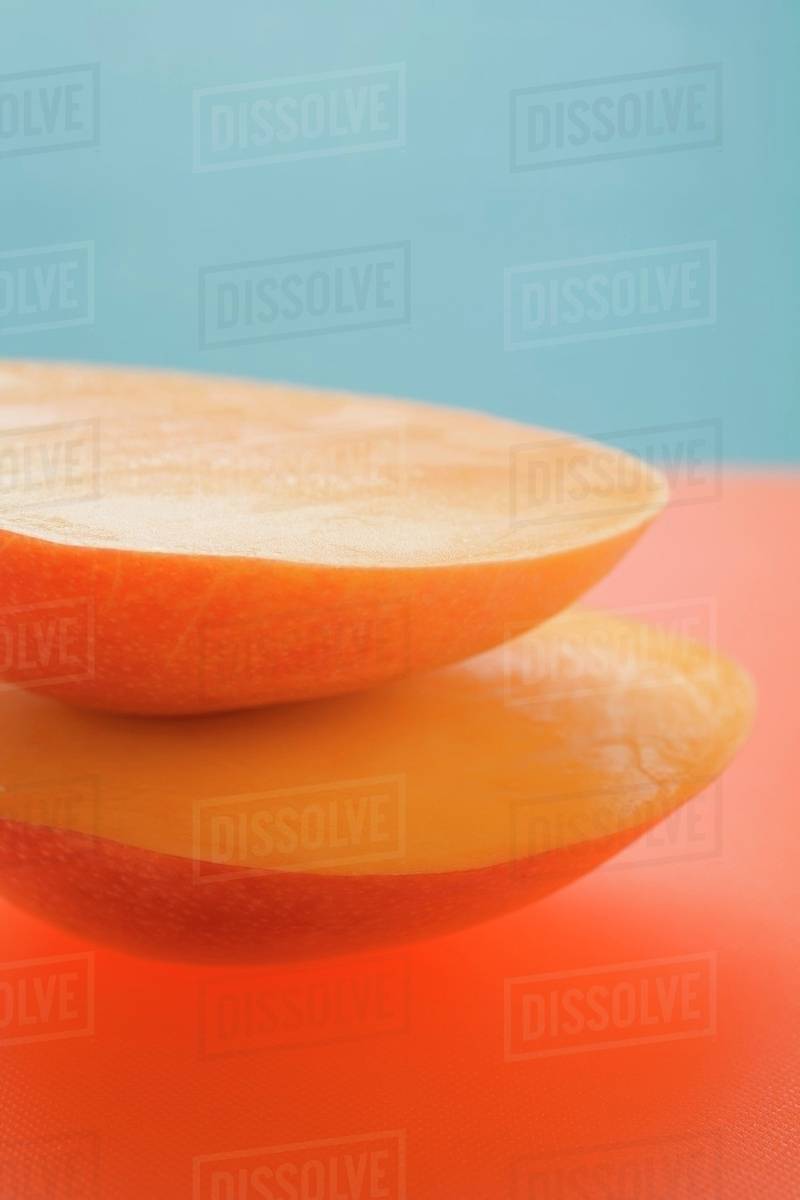 Two mango halves - Royalty-free Stock Photo | Dissolve