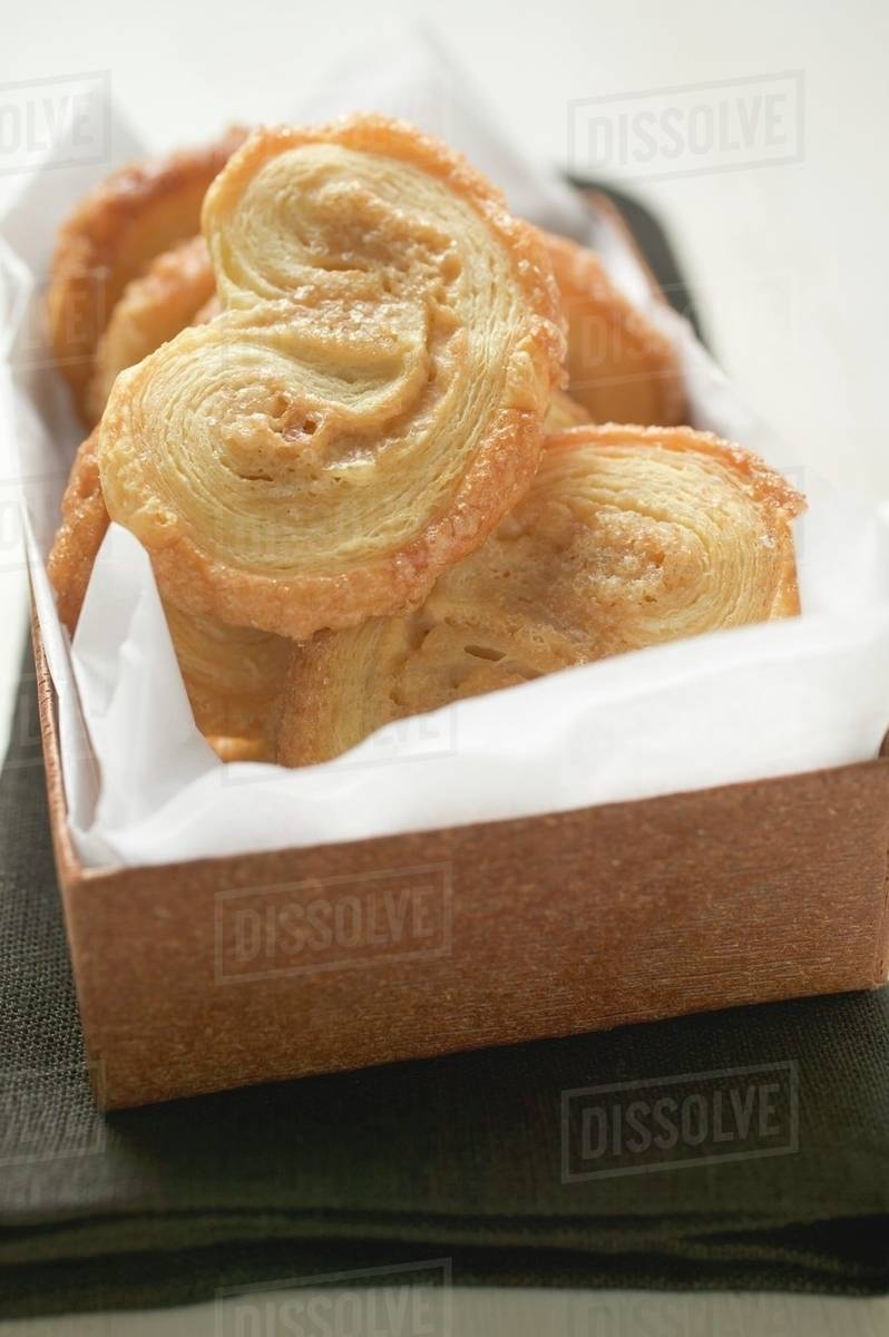 Palmiers (puff pastry biscuits) in box - Stock Photo - Dissolve