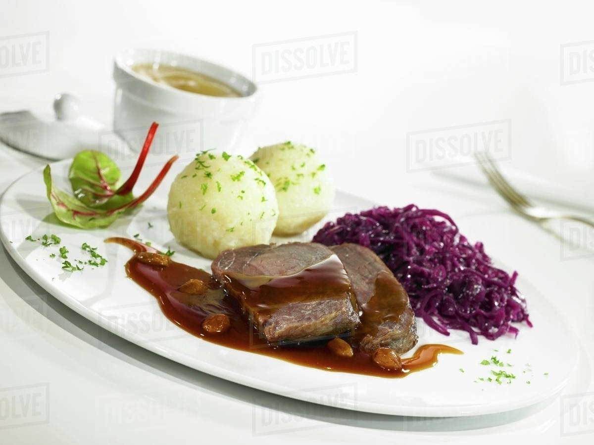 Sauerbraten (braised beef in vinegar) with red cabbage and potato ...