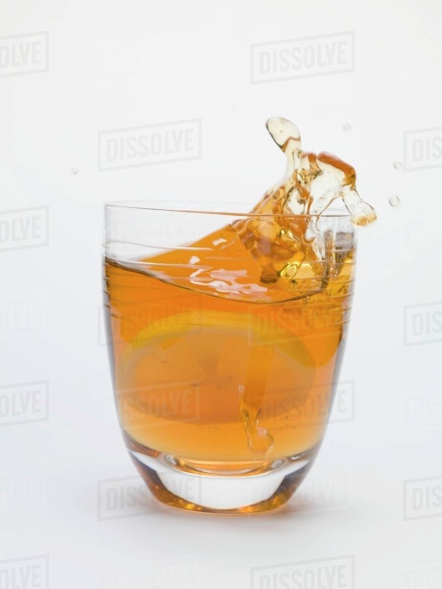 Iced tea splashing out of a glass - Royalty-free Stock Photo | Dissolve