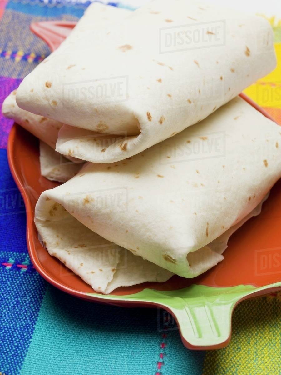 Tortilla parcels in chilli pepper shaped dish - Royalty-free Stock ...