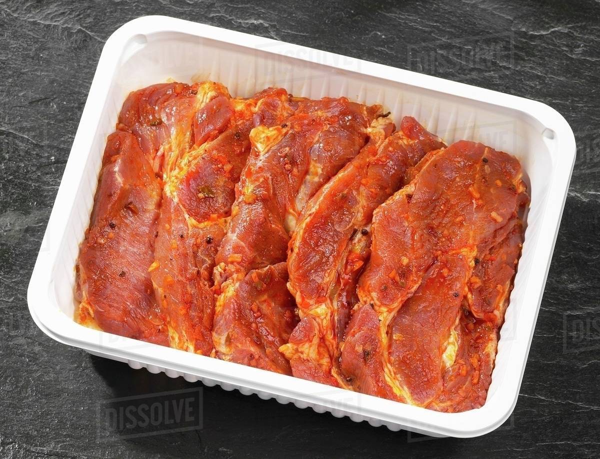 Marinated pork neck steaks in plastic container - Royalty-free Stock ...