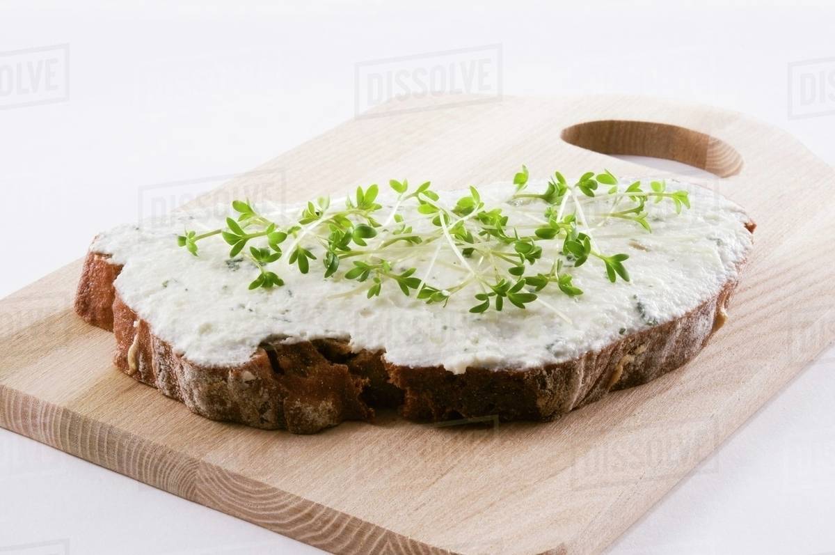 Quark and bread with fresh cress on chopping board - Royalty-free Stock ...