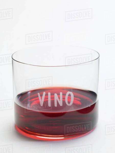 Glass of red wine with the word Vino - Stock Photo - Dissolve