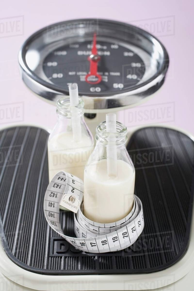 Two bottles of milk with tape measure on scales - Royalty-free Stock ...
