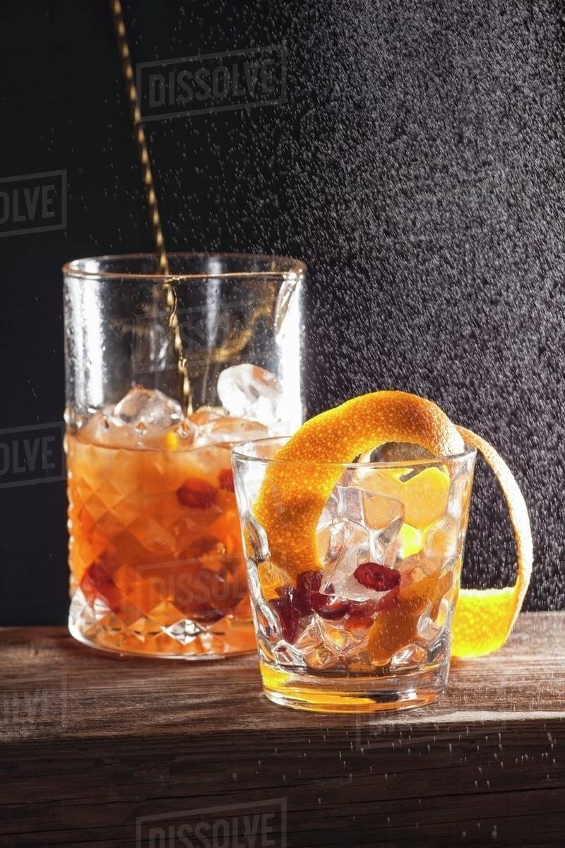 An alcoholic cocktail made with fruits and orange zest - Royalty-free ...