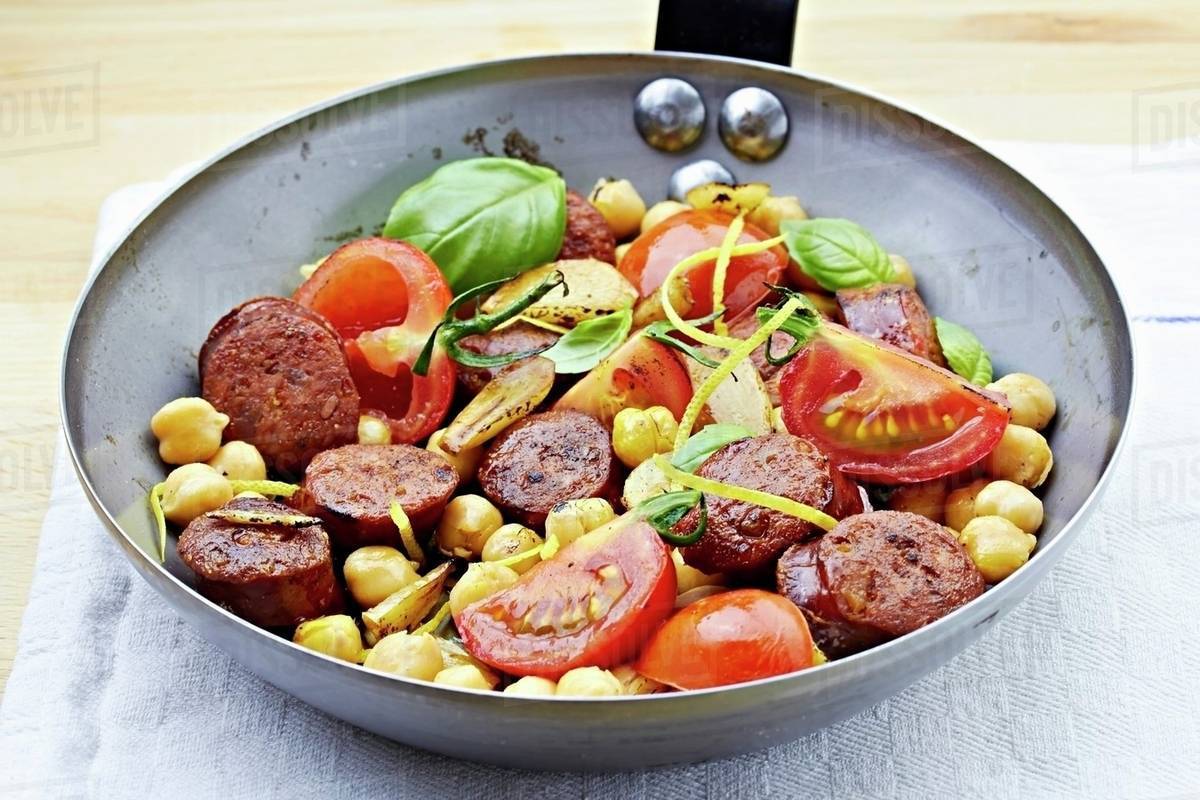 Fried chorizo chickpea with tomatoes and basil - Royalty-free Stock ...