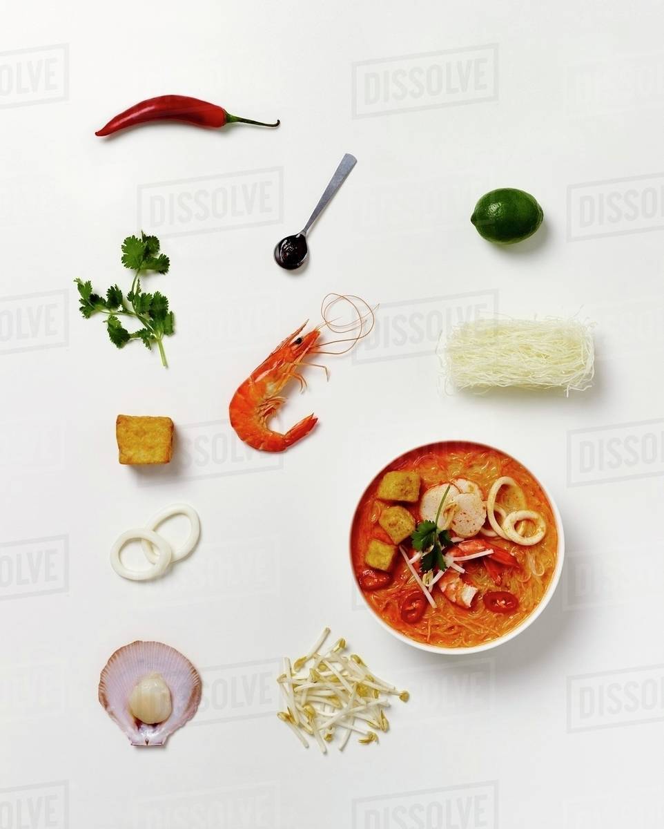 Laksa (seafood and noodle soup, South East Asia), surrounded by ...