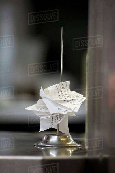 Chits on spike in working restaurant - Royalty-free Stock Photo | Dissolve