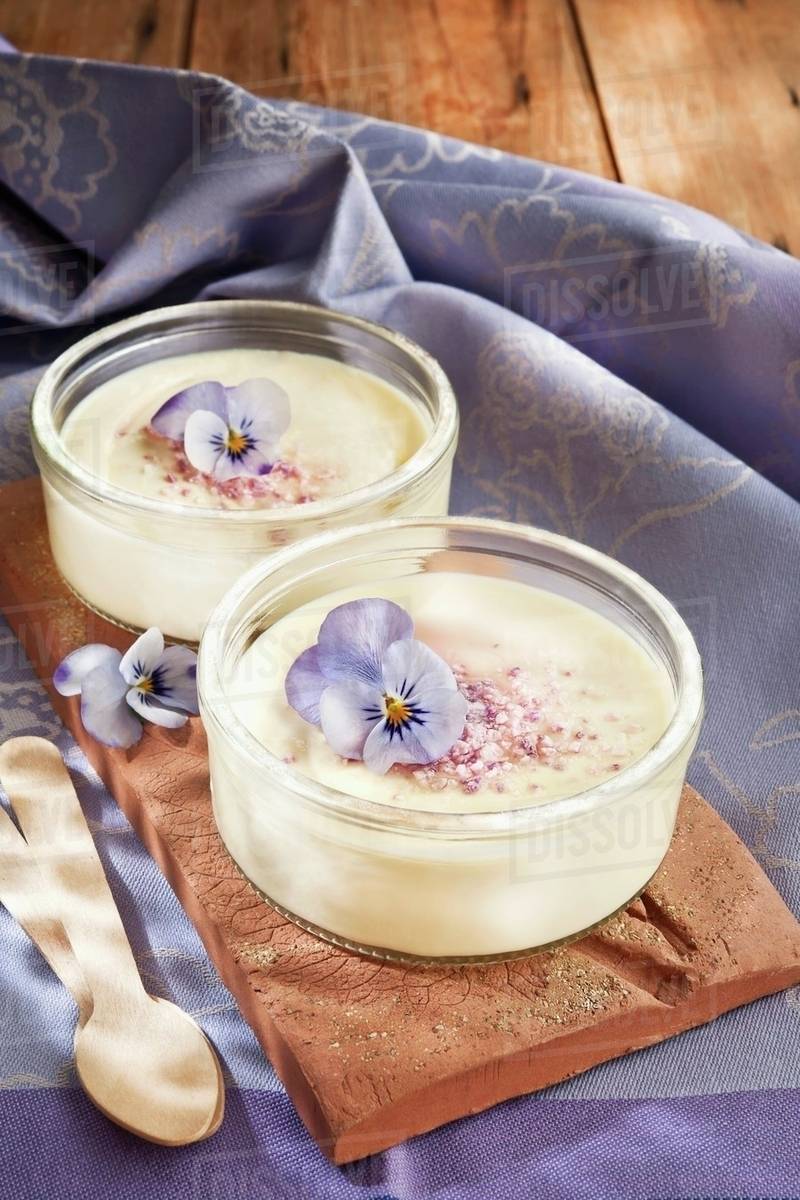 Cream desserts with edible flowers - Royalty-free Stock Photo | Dissolve