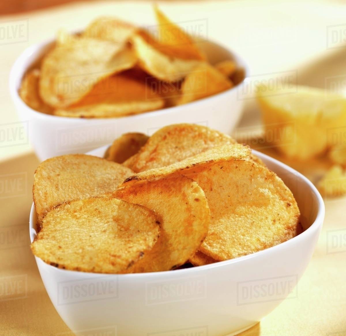 Bowls of cheesy potato chips - Royalty-free Stock Photo | Dissolve