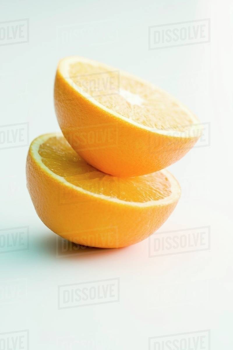 An Orange, Sliced in Half - Stock Photo - Dissolve