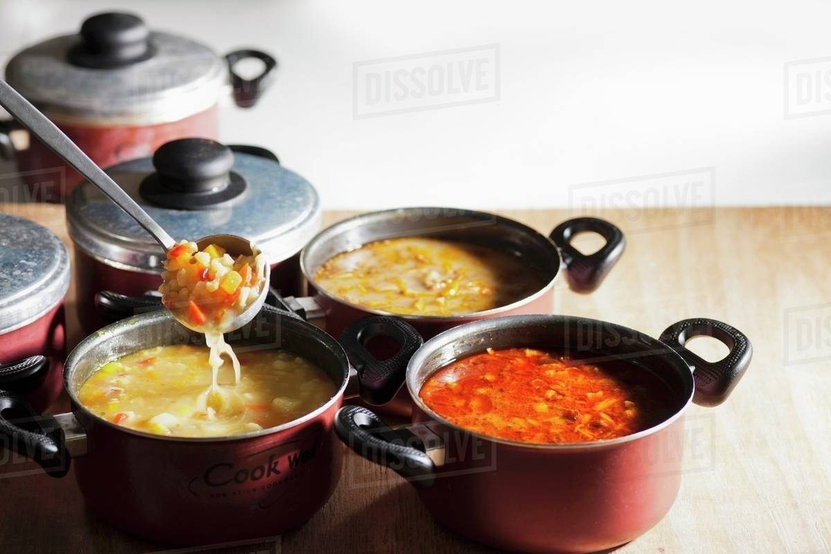 Various vegetable soups in pots - Stock Photo - Dissolve