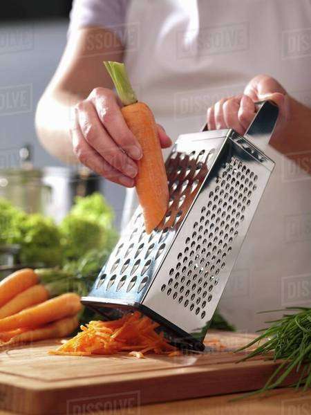 Grating carrots - Royalty-free Stock Photo | Dissolve