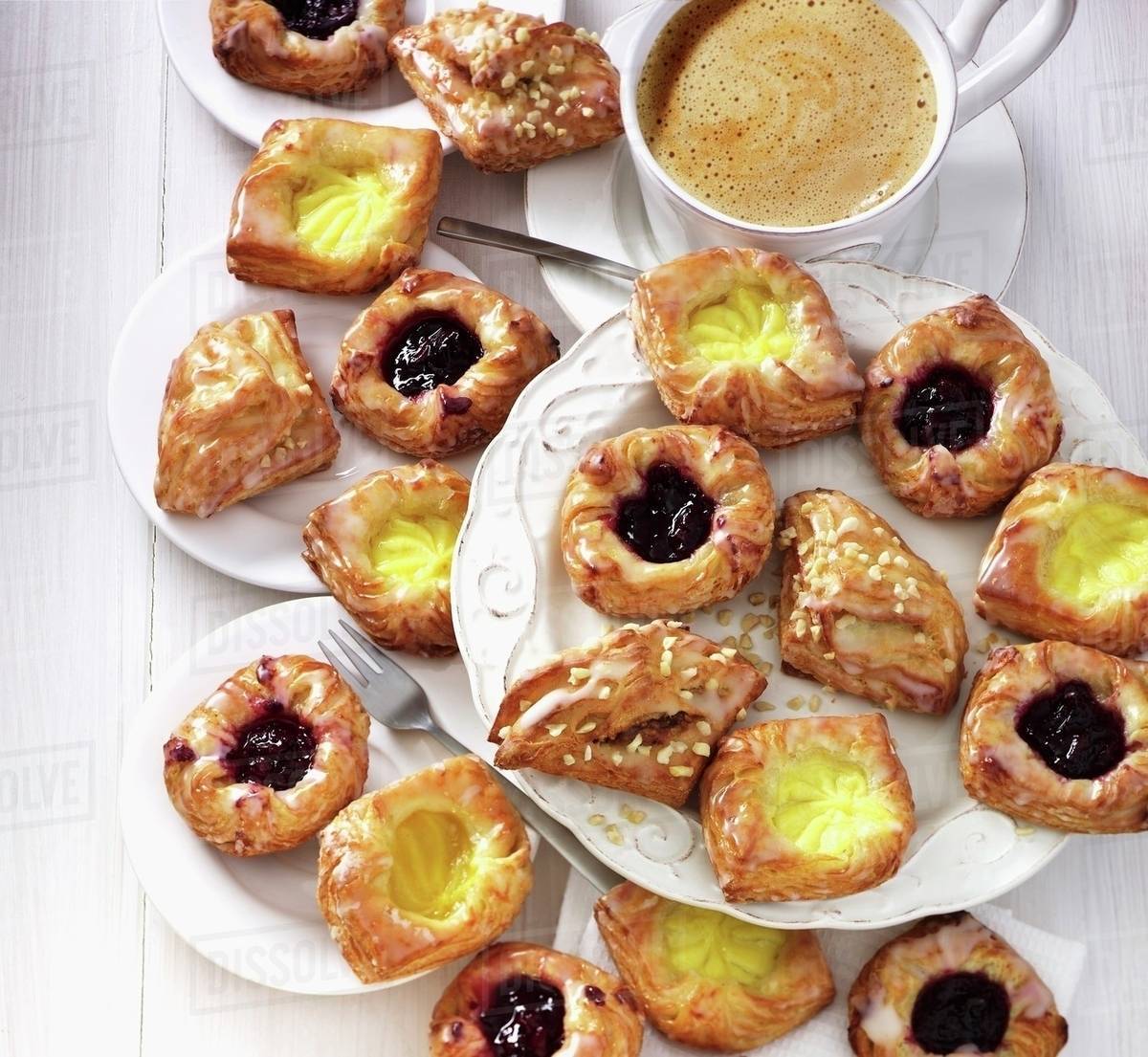 Various Danish pastries served with coffee - Stock Photo - Dissolve
