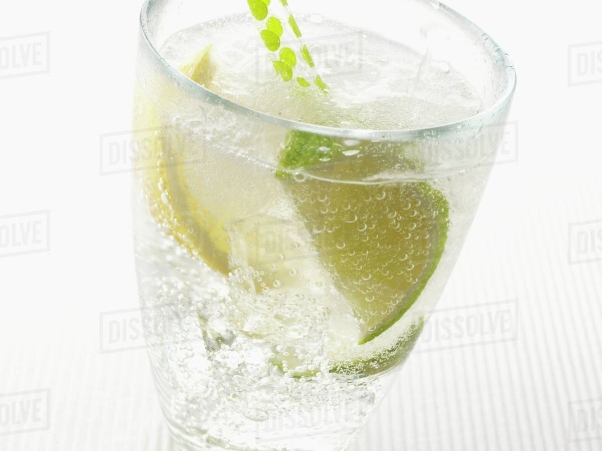 Sparkling mineral water with ice cubes and a lemon and lime wedge - Royalty-free Stock Photo ...