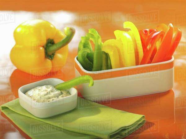 Colourful pepper sticks with a dip - Royalty-free Stock Photo | Dissolve
