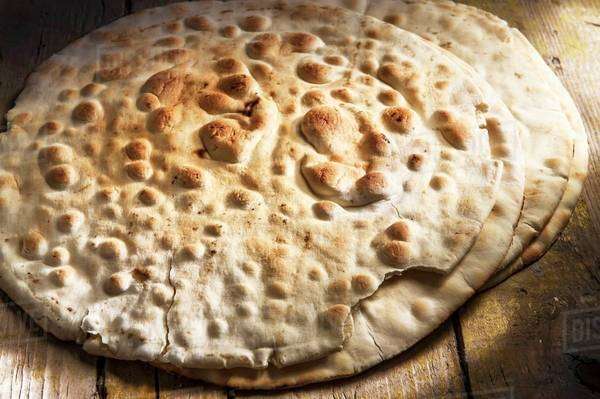 Spianata Sarda bread, Sardinia, Italy - Stock Photo - Dissolve