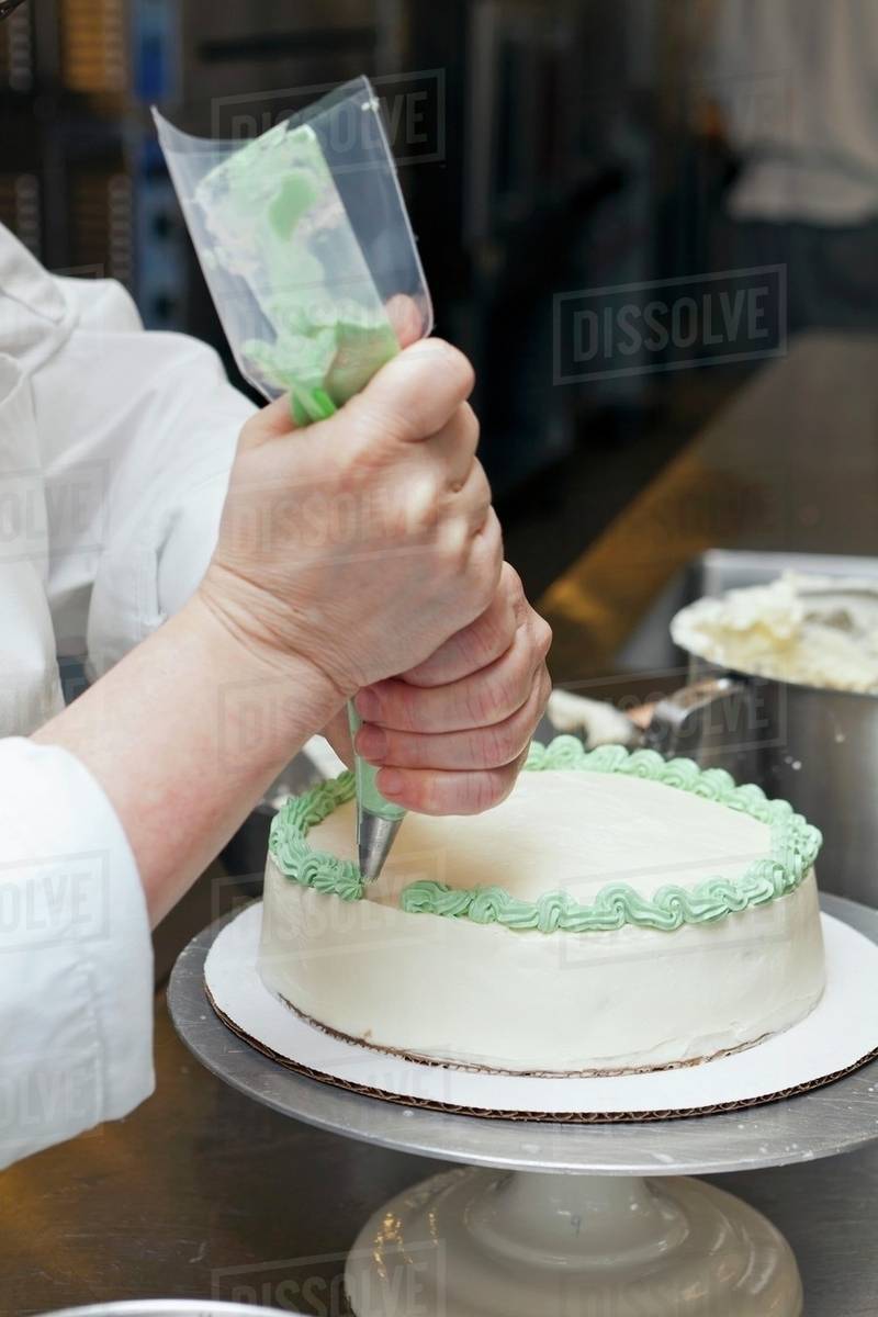 A chef icing a cake - Royalty-free Stock Photo | Dissolve
