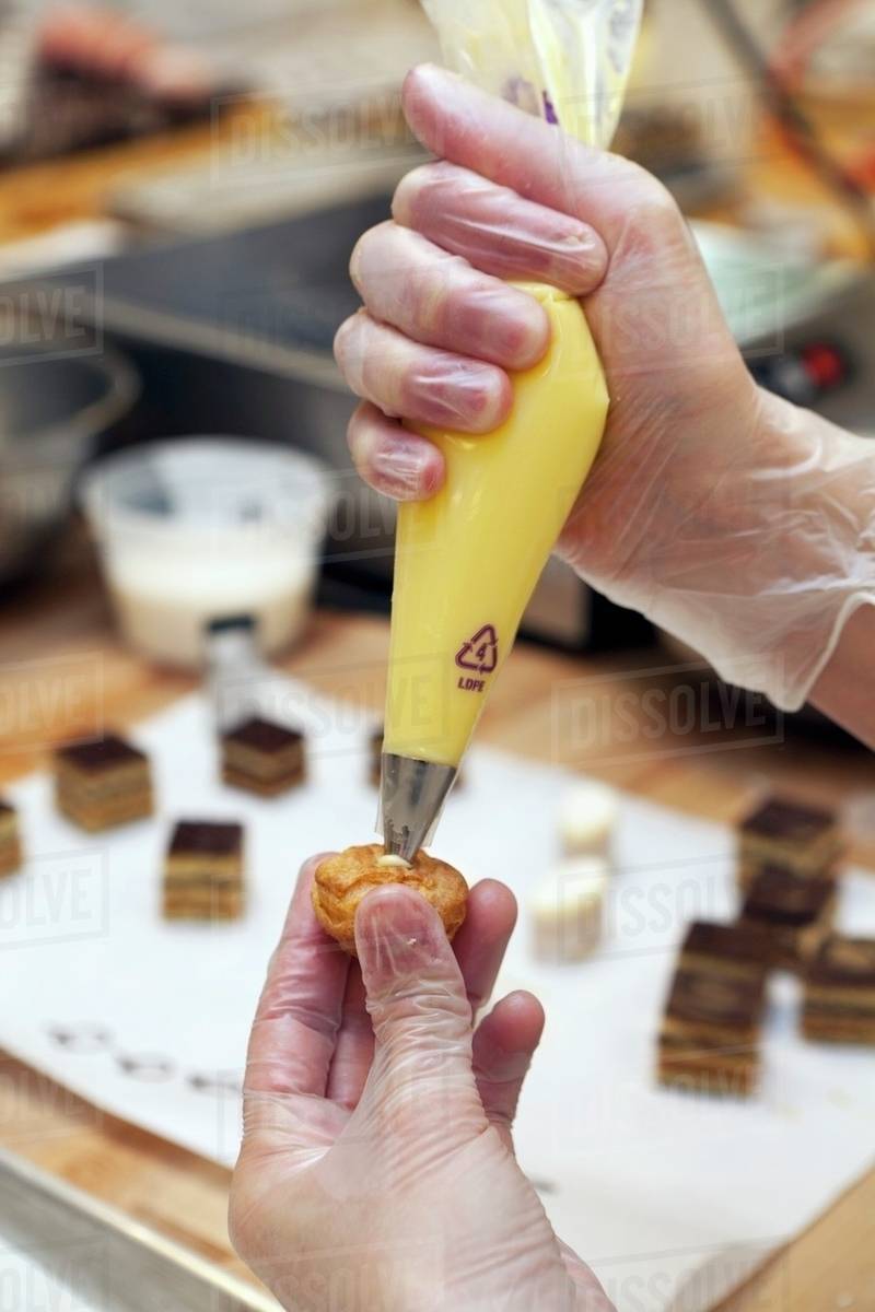 A chef filling a profitable with cream - Royalty-free Stock Photo ...