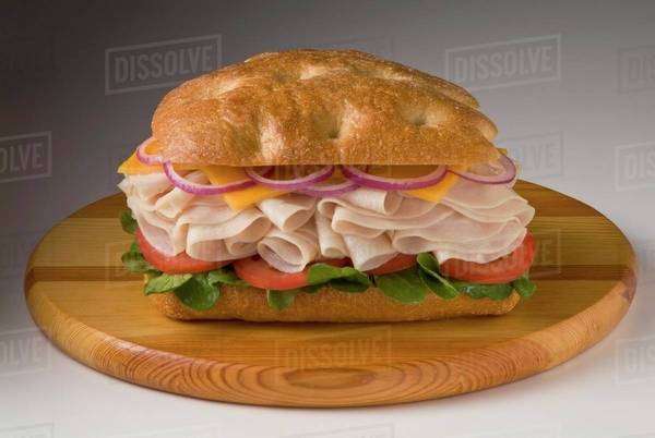 Turkey ham, cheese, onions and tomatoes on a ciabatta roll - Royalty ...