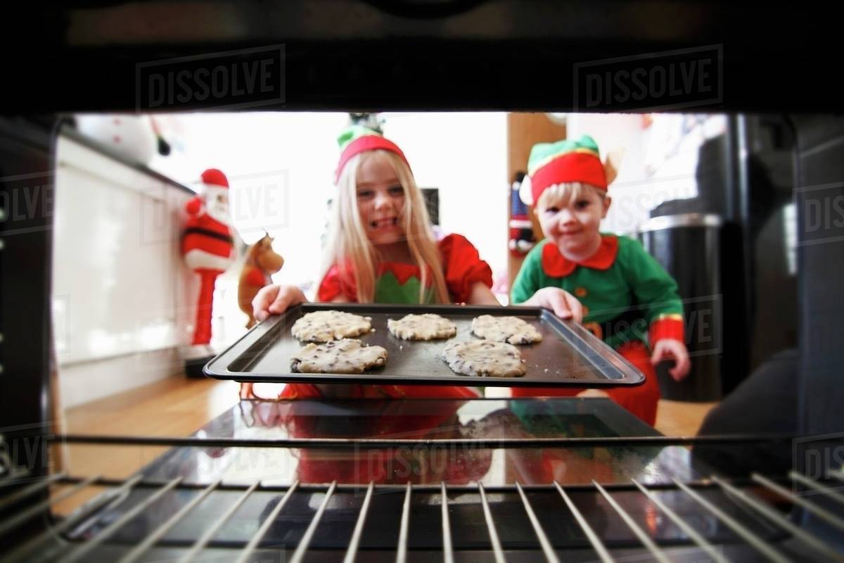 Two children baking Christmas biscuits - Royalty-free Stock Photo ...