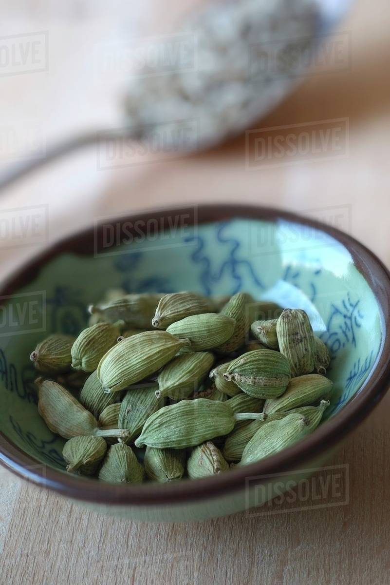 Green cardamom in a ceramic bowl - Royalty-free Stock Photo | Dissolve