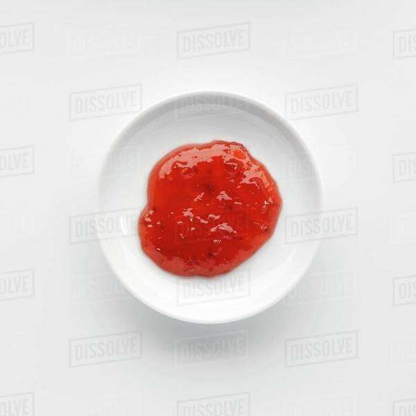 A portion of raspberry jam on a plate - Royalty-free Stock Photo | Dissolve