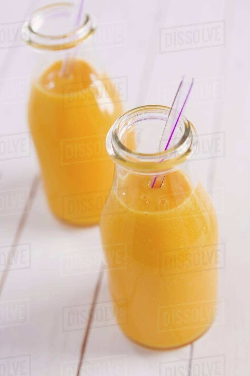 Two bottles of orange juice with straws - Royalty-free Stock Photo ...