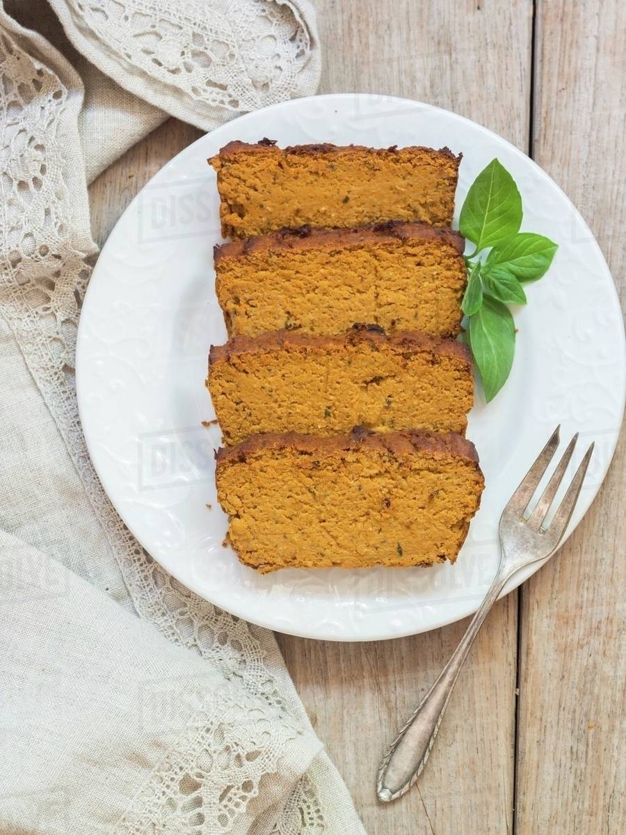 Homemade vegan chickpea cake with basil leaves - Stock Photo - Dissolve