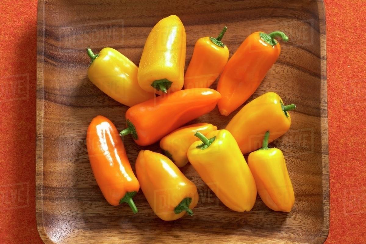 Yellow and orange mini peppers in a wooden crate - Royalty-free Stock ...