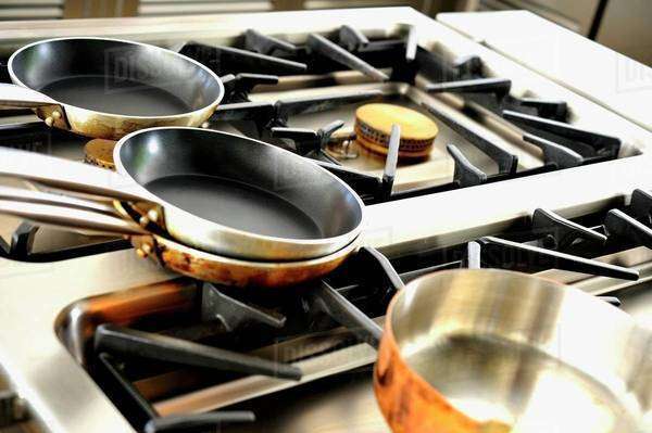 Various pots on a gas cooker - Royalty-free Stock Photo | Dissolve