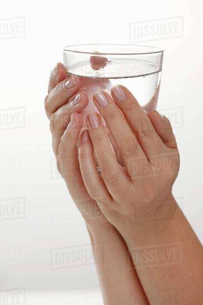 Hands holding a glass of water - Royalty-free Stock Photo | Dissolve