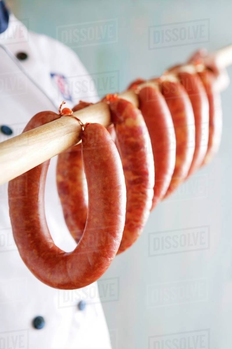 Dutch rookworst hanging on a stick - Royalty-free Stock Photo | Dissolve